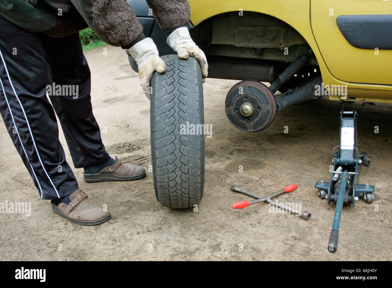 Man changing a tire Stock Photo - Alamy