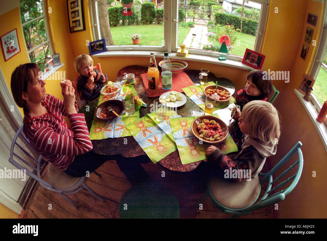 Mother and her children eating lunch, Berlin, Germany Stock Photo - Alamy