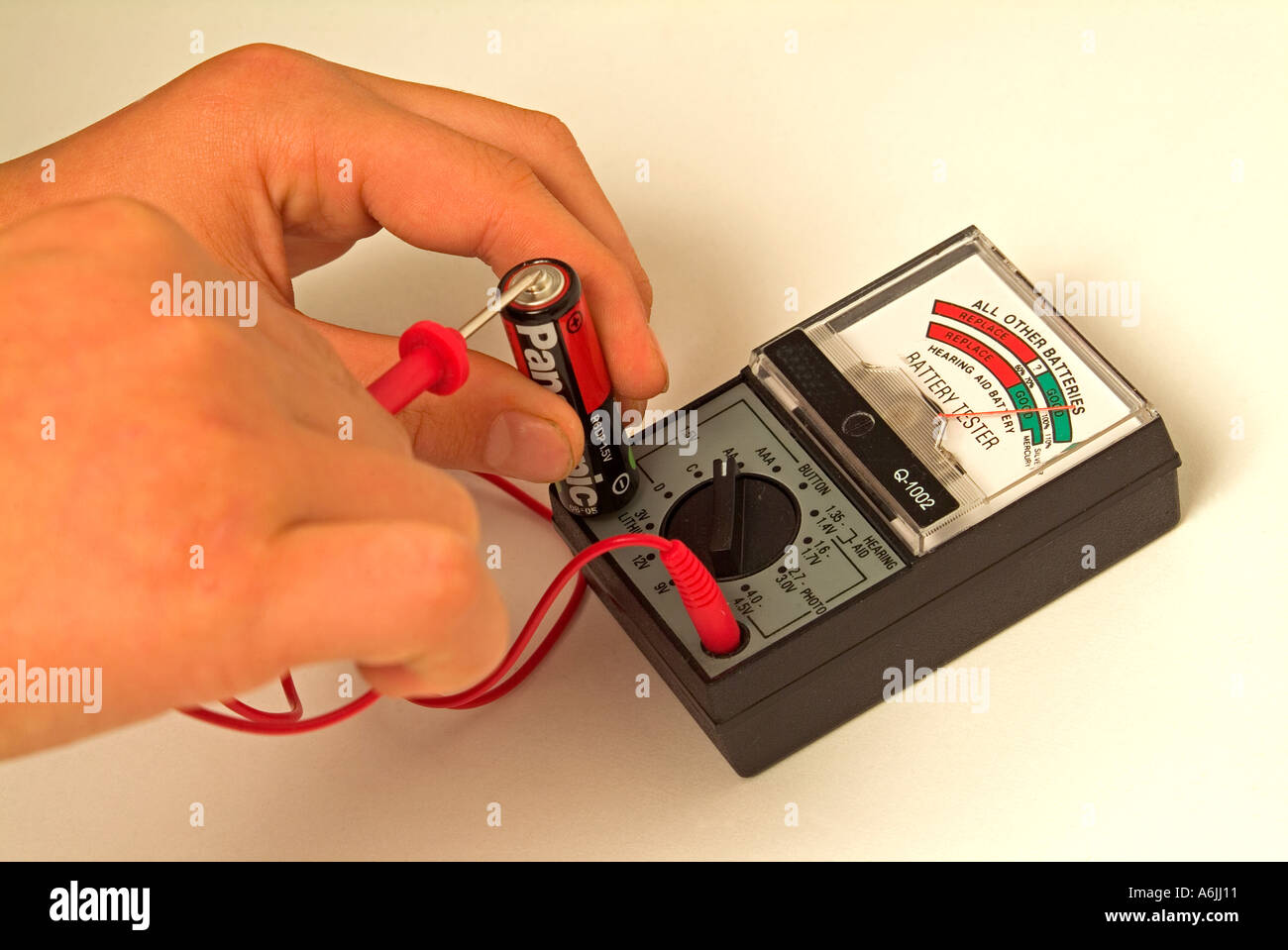 Testing a AA battery on an old style analogue battery tester Stock ...
