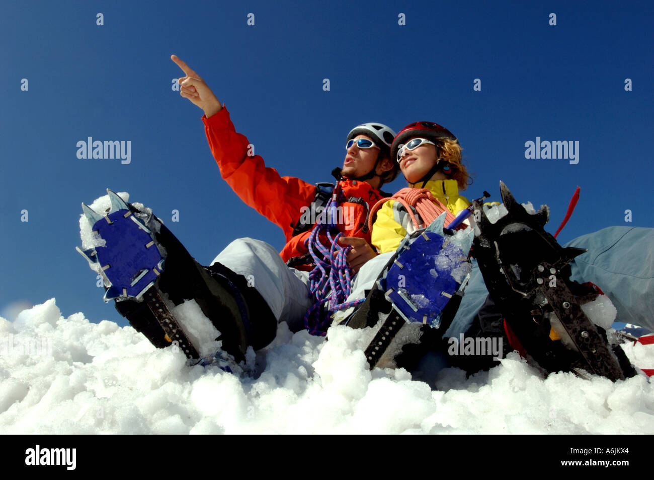 young mountaineer couple sitting in snow Stock Photo - Alamy