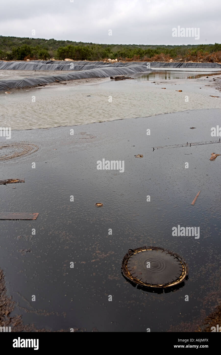 Crude oil in holding pits on an oil field in West Texas waste from a ...