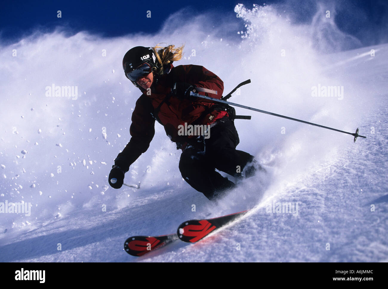 Female skier in crash helmet off piste heli skiing at Points North Heli ...
