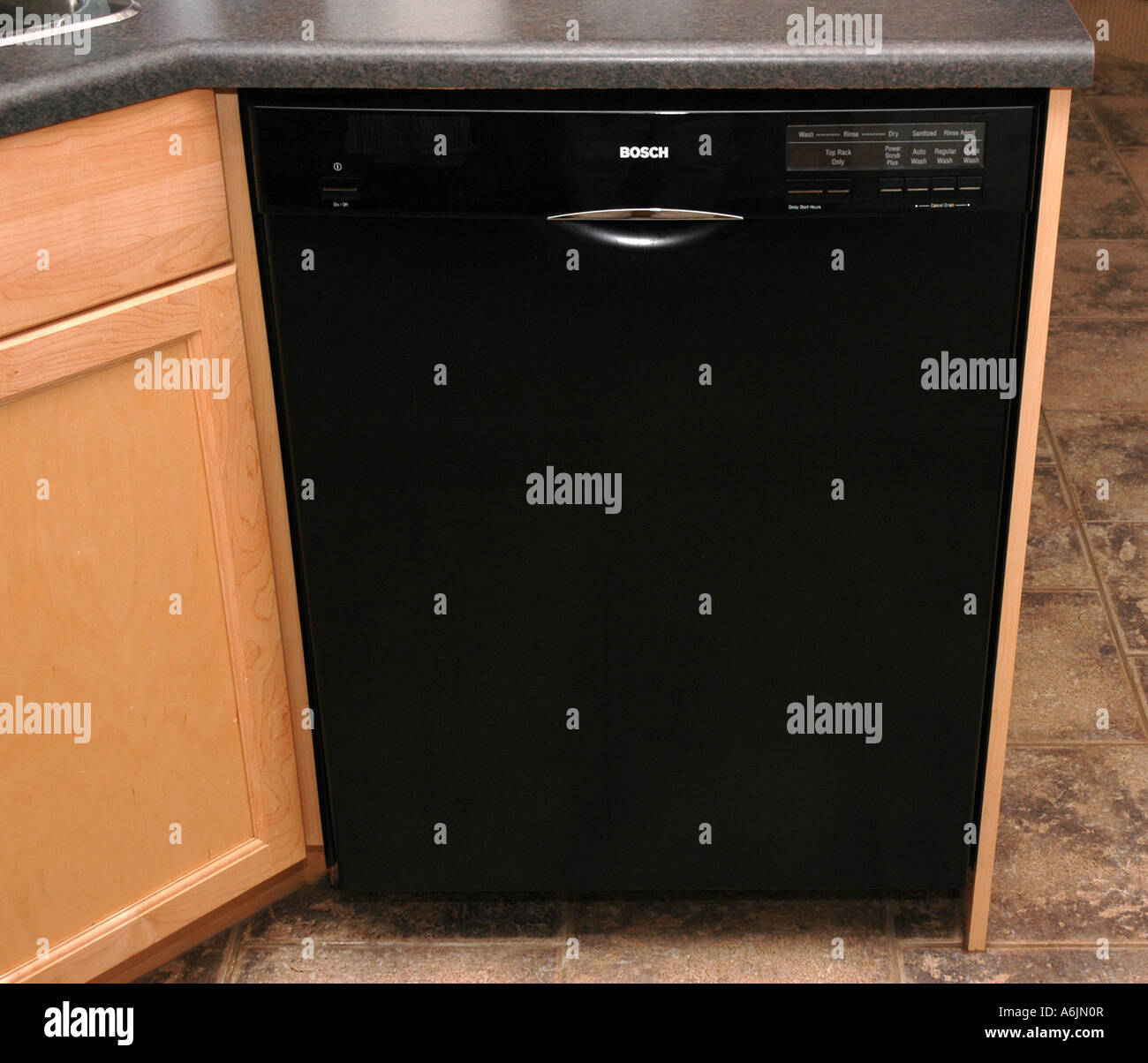 Black kitchen dishwasher countertop cupboard and tile flooring Stock ...