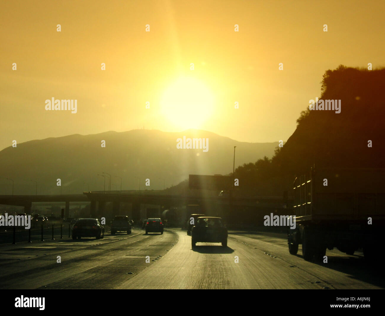 Driving on highway with sun straight ahead Stock Photo - Alamy