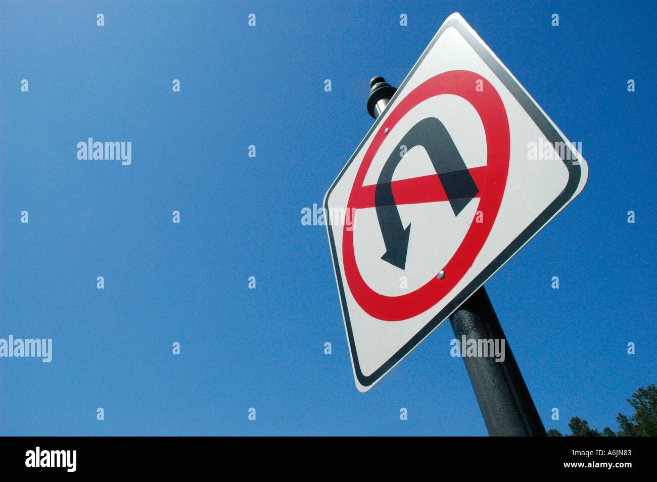 No U turn permitted at this corner sign on road around Stock Photo - Alamy