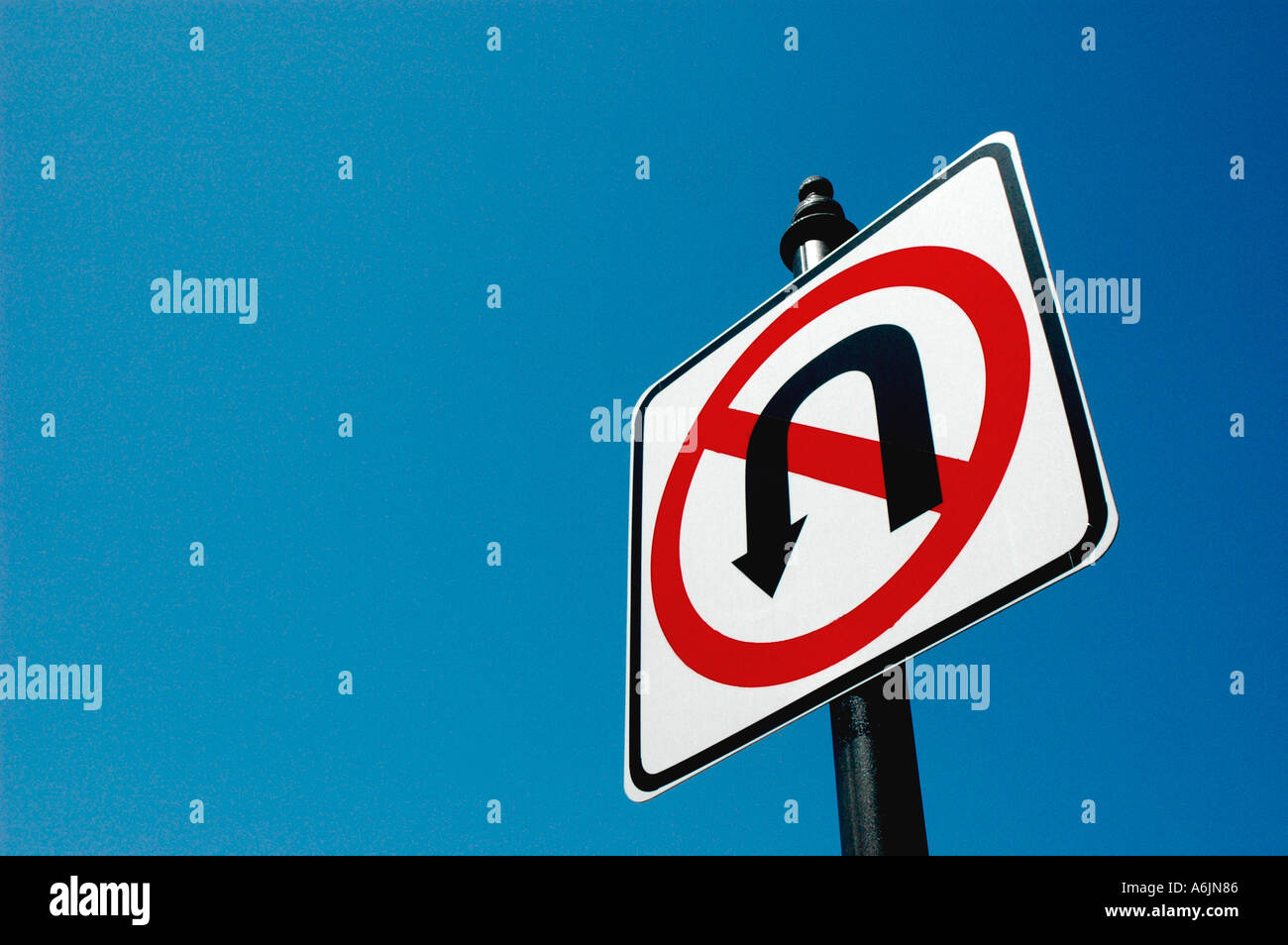 No U turn permitted at this corner sign on road around Stock Photo - Alamy