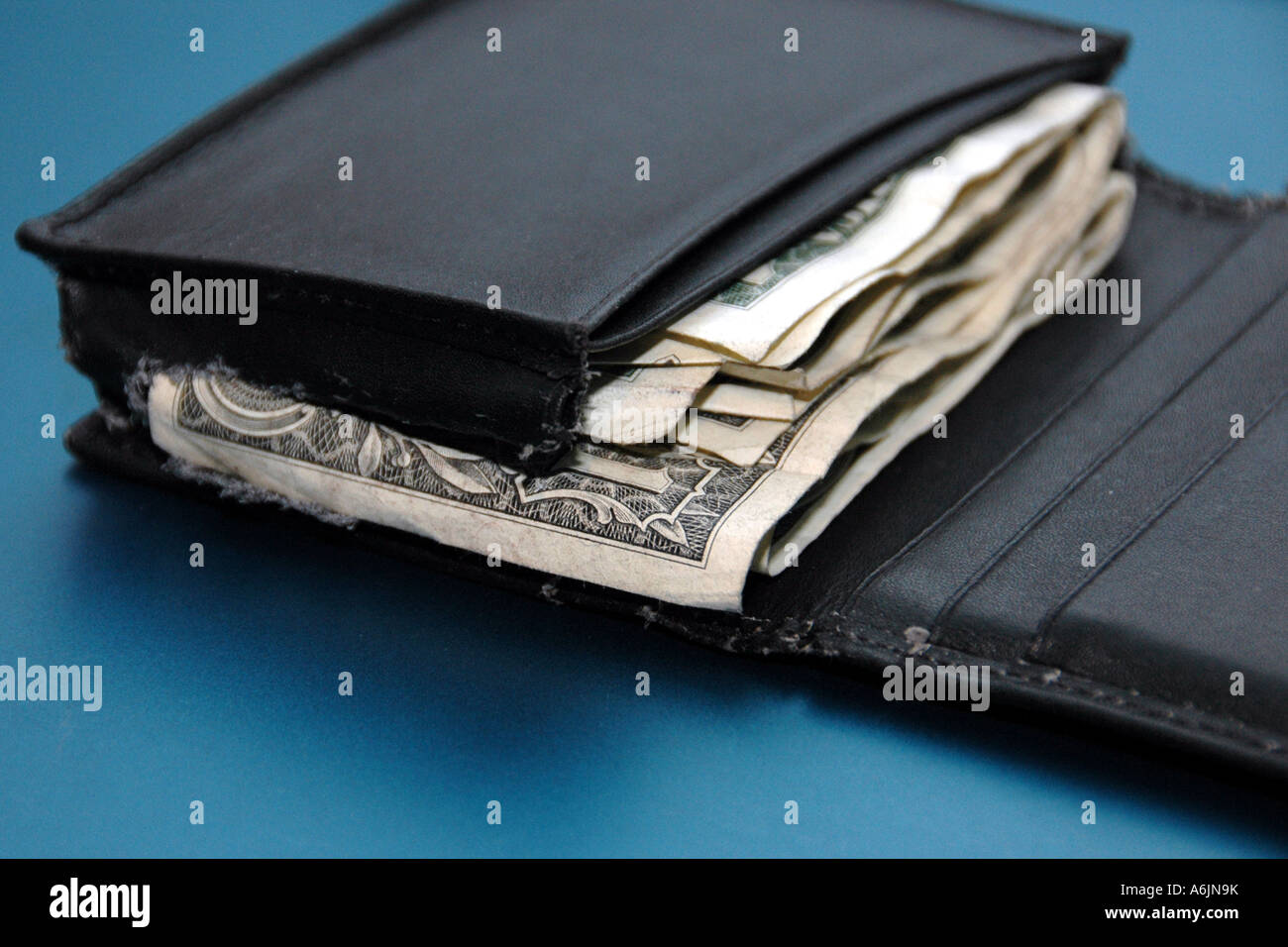 Money inside a ripped worn out wallet Stock Photo - Alamy