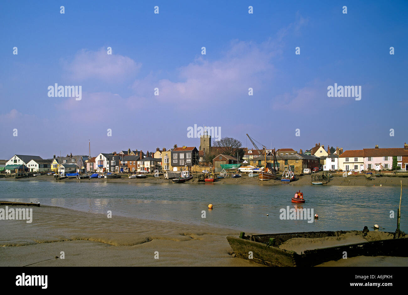 small port with a mix of brick and brightly painted wooden cottages on ...