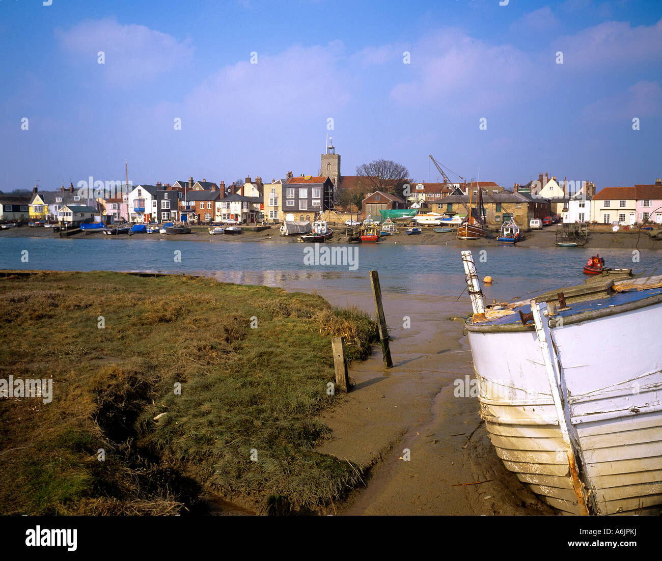 small port with a mix of brick and brightly painted wooden cottages on ...