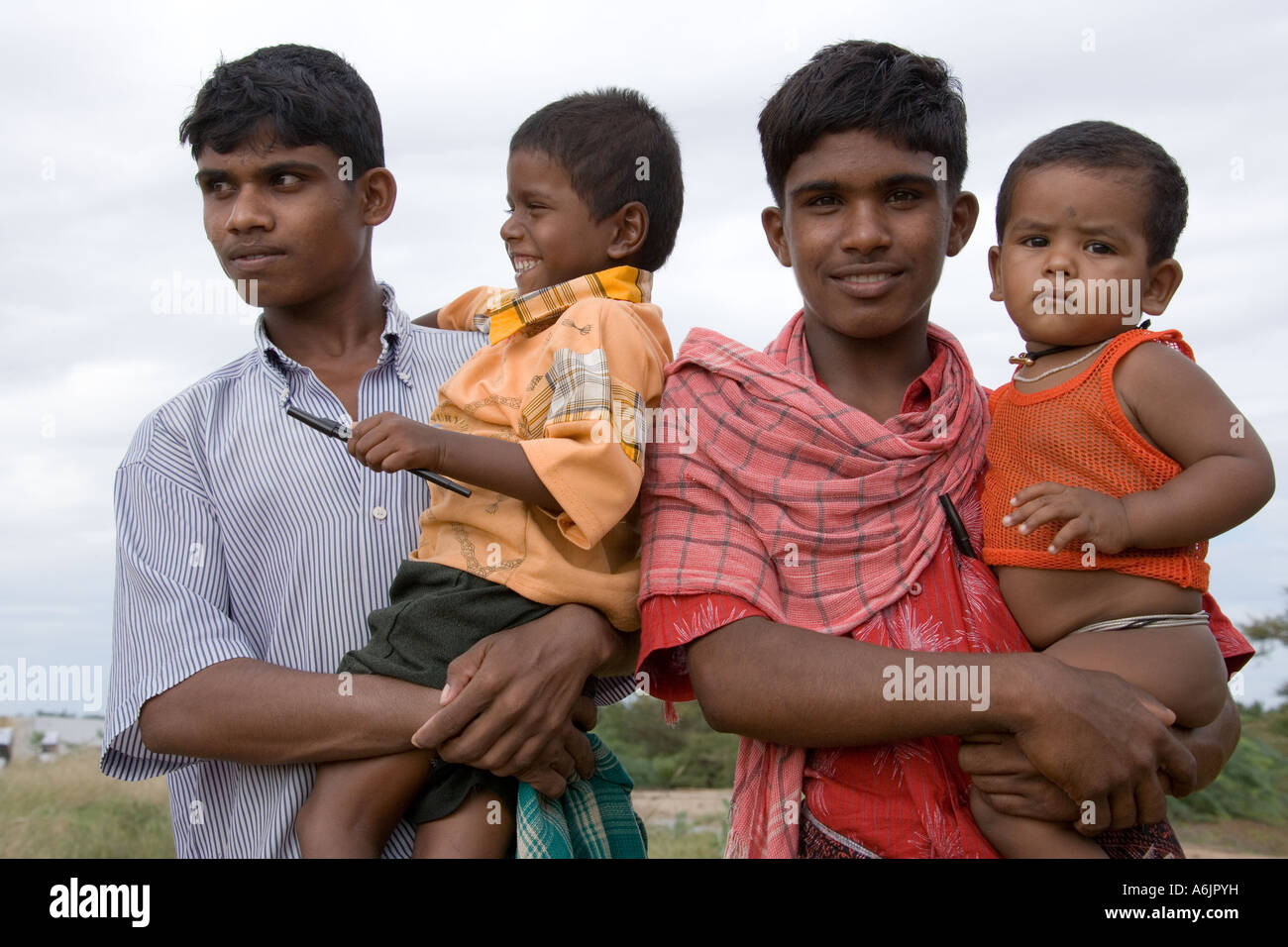 Young Tamil men holding there sons in the Chettinad area of Tamil Nadu ...