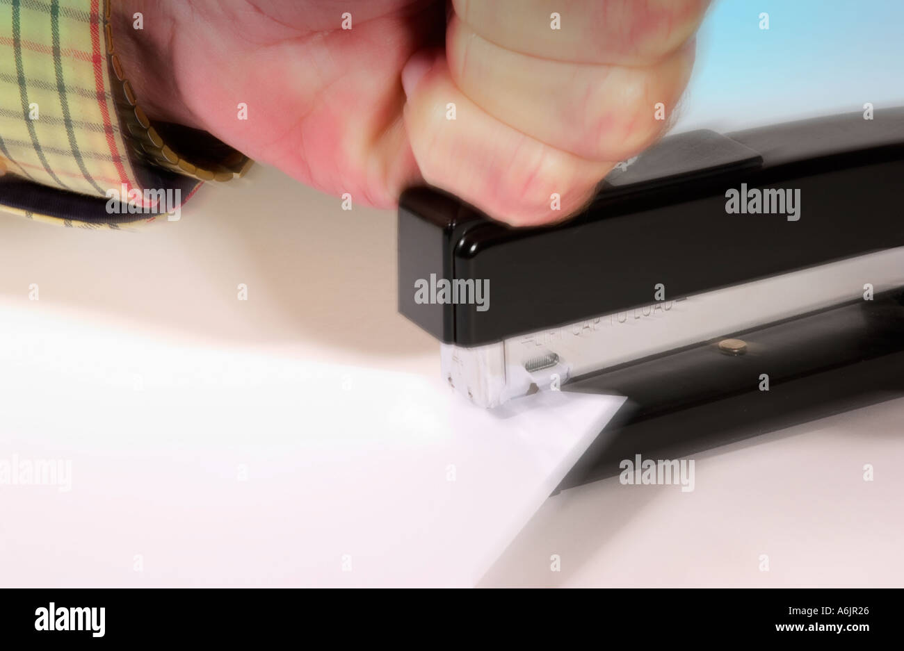 Stock Photo of Caucasian Male Stapling Paper USA Stock Photo - Alamy