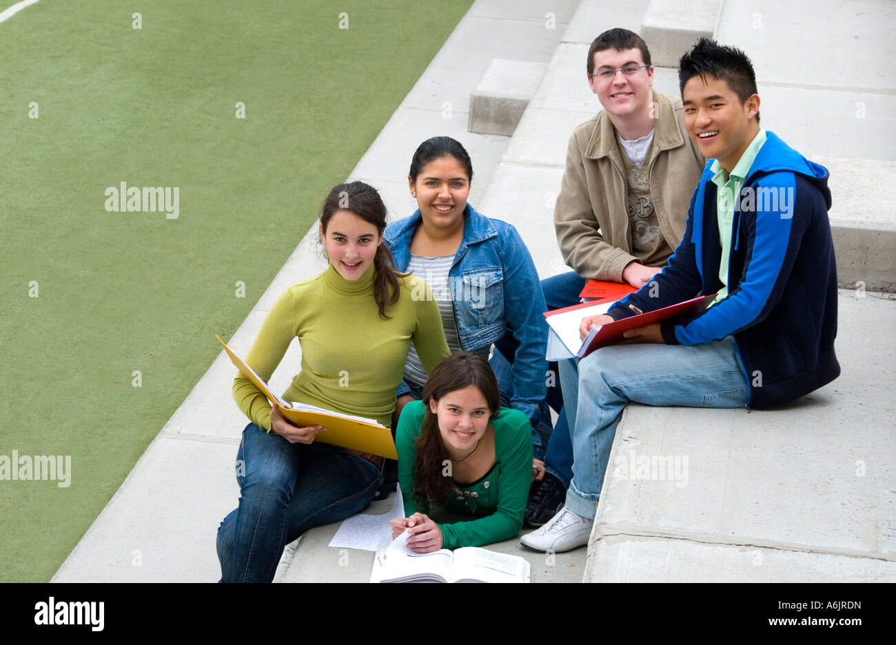Multiracial group of five teenage senior students sitting and relaxing ...