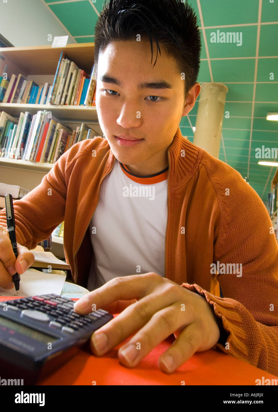 Teenage 14-17years Korean school boy student with his calculator in ...