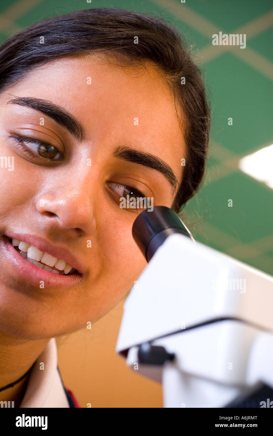 Asian ethnic Teenage 15-17 years girl student looking through her ...