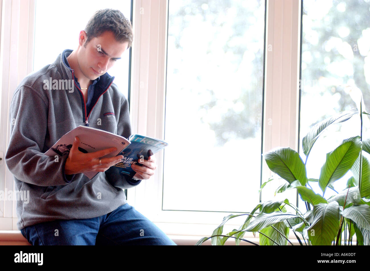 British business man reading informal magazine office London UK Stock ...