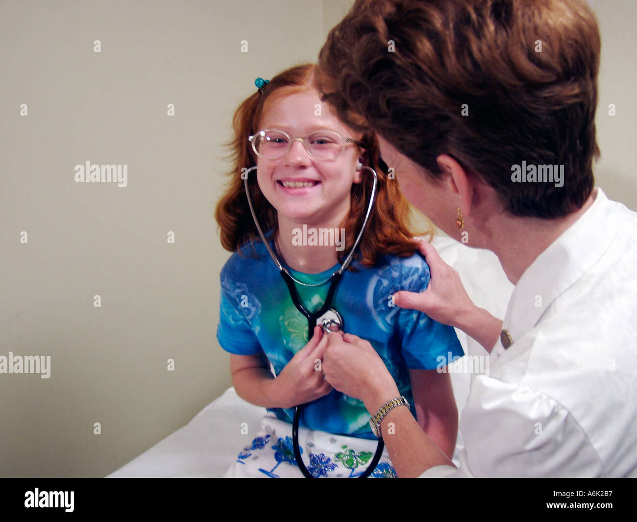 Young girl checking out her heartbeat with a stethoscop Stock Photo - Alamy