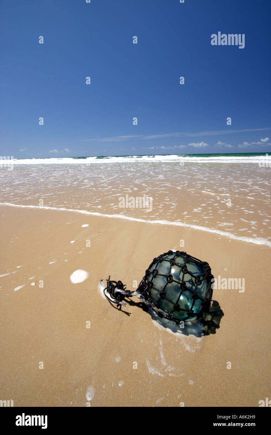 GLASS FLOAT WASHED UP ON BEACH VERTICAL BAPDB5822 Stock Photo - Alamy