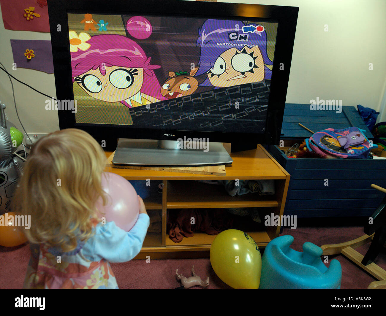 Two Year Old with Balloon Watching Flat Screen Television Stock Photo ...