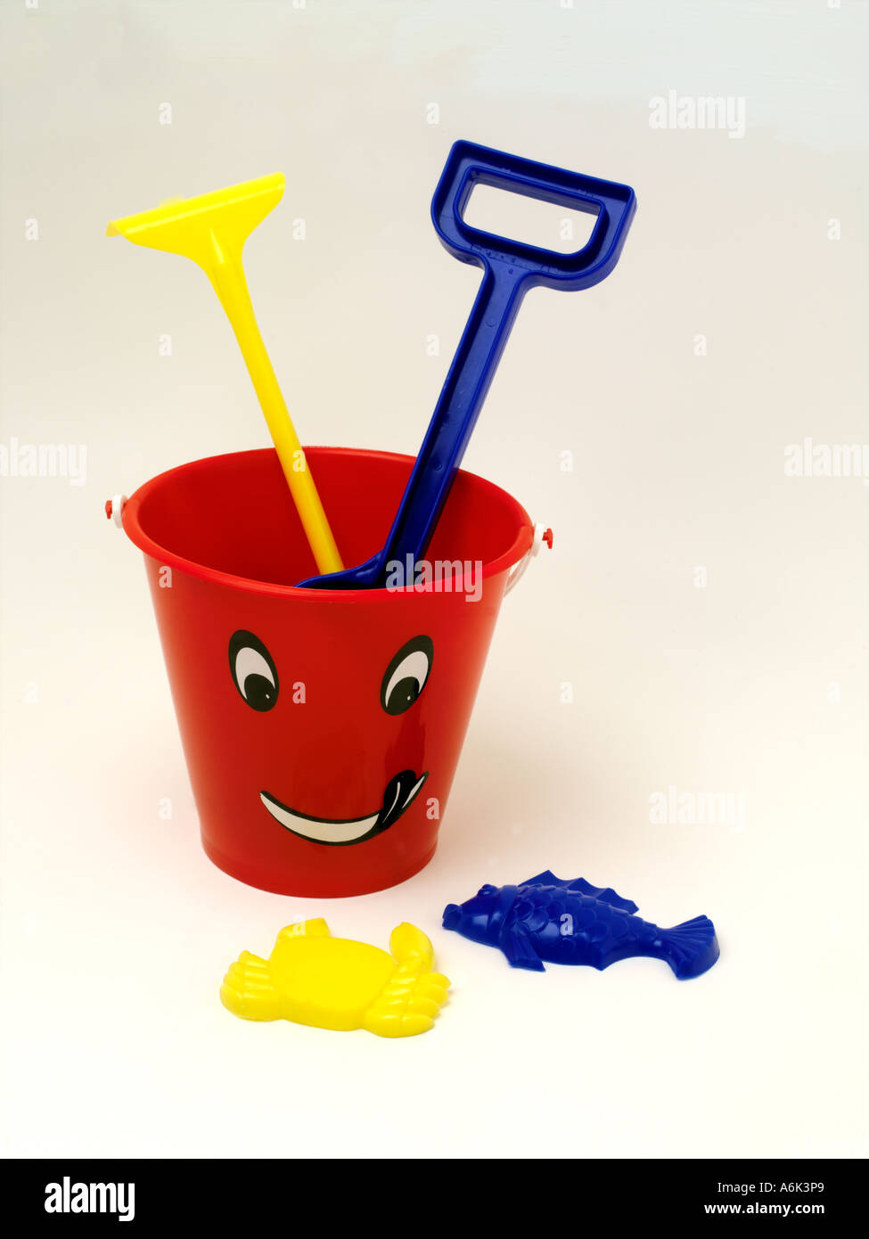 Red Plastic Bucket with Smiley Face Blue Plastic Spade Yellow Plastic ...