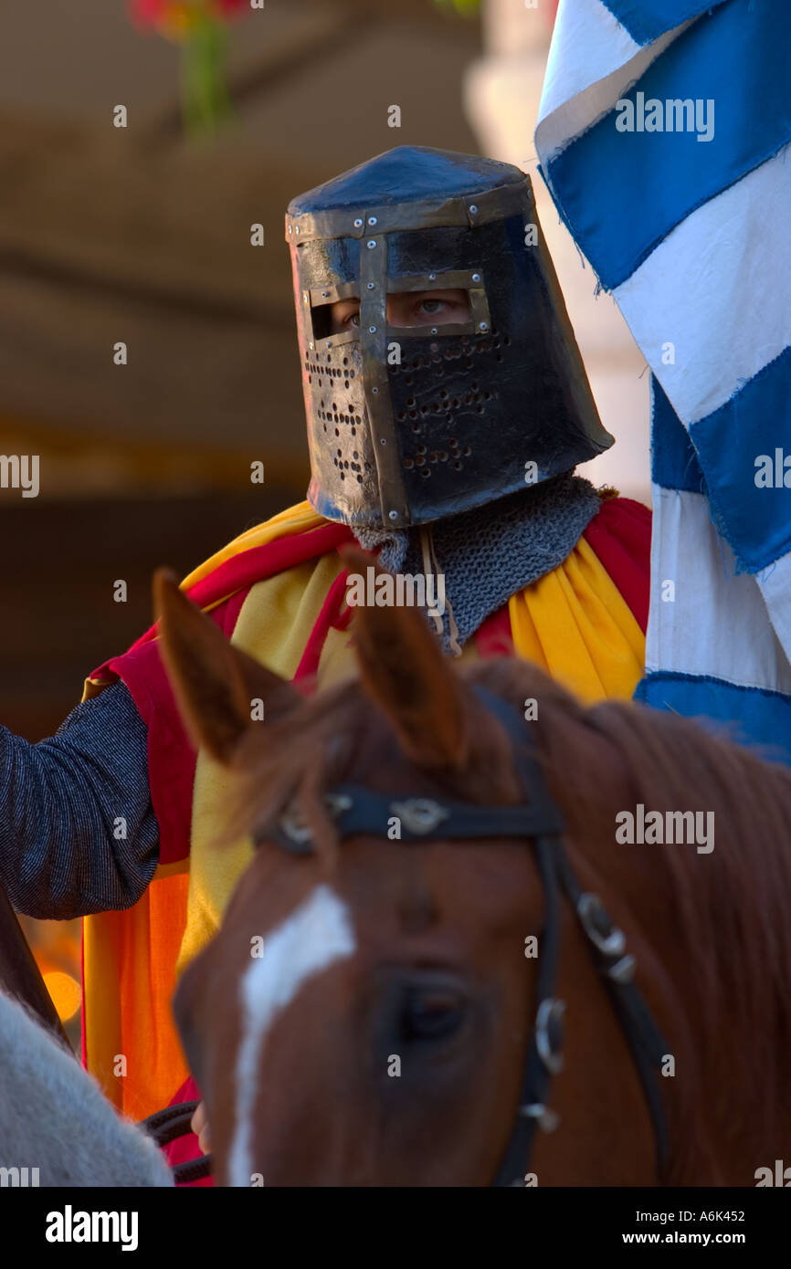 French medieval knight on horseback, man looking through helmet in ...