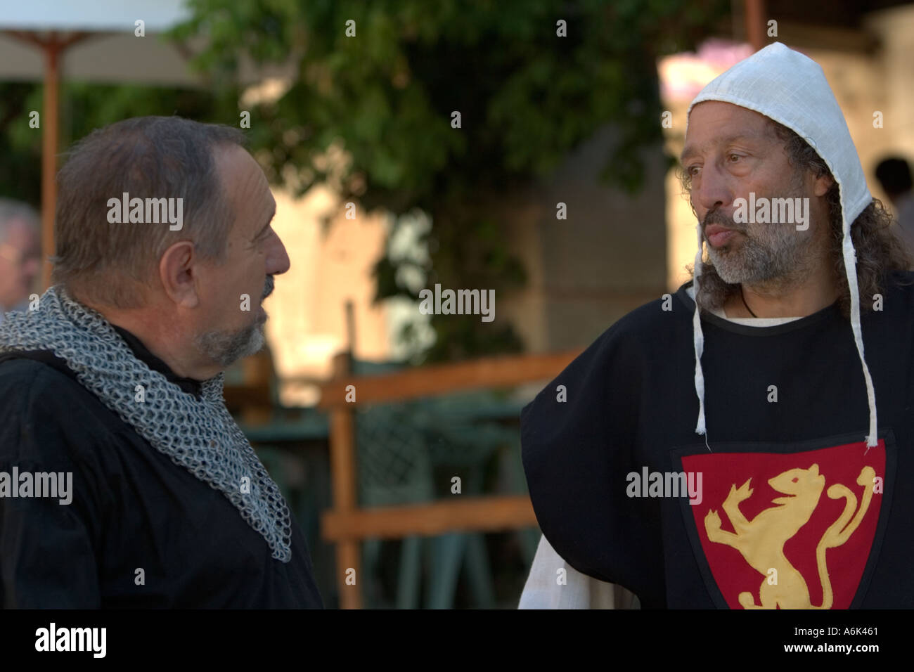 Two men dressed in medieval costume in conversation at medieval ...