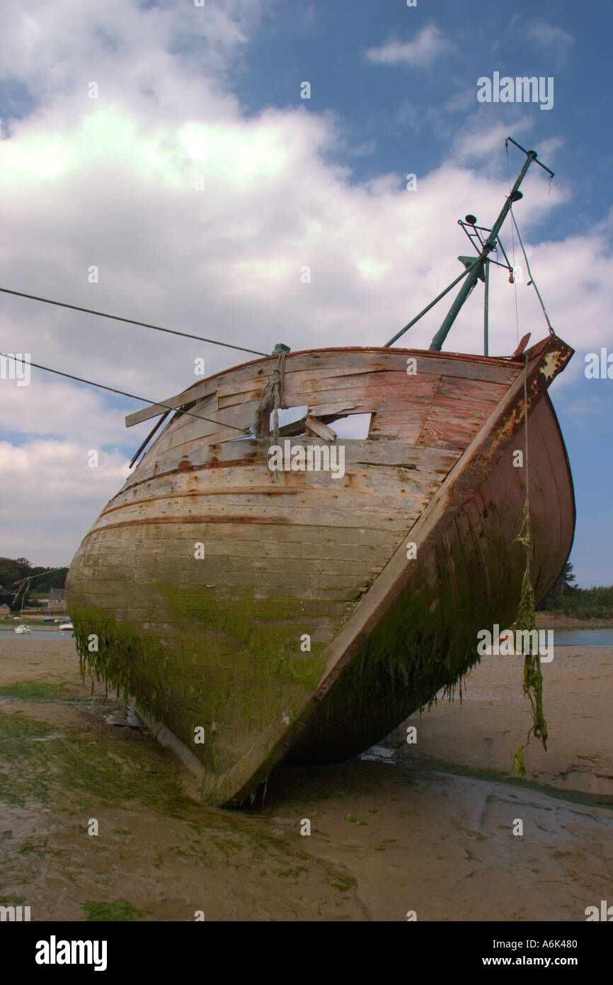 Derelict wooden Boat on beach with algal growth, biofouling on hull at ...