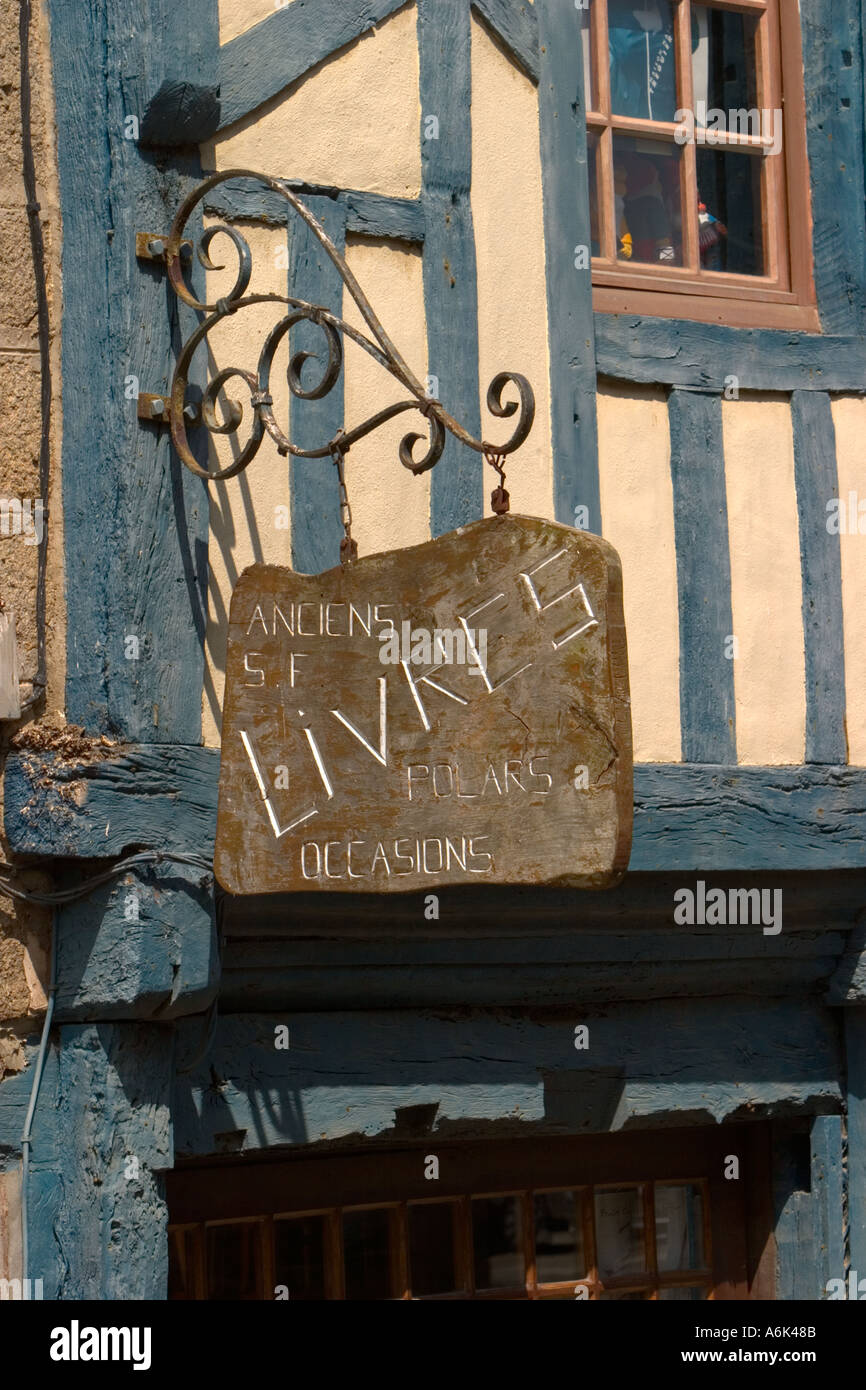 Shop sign hanging from ornamental metal bracket on Medieval building in ...