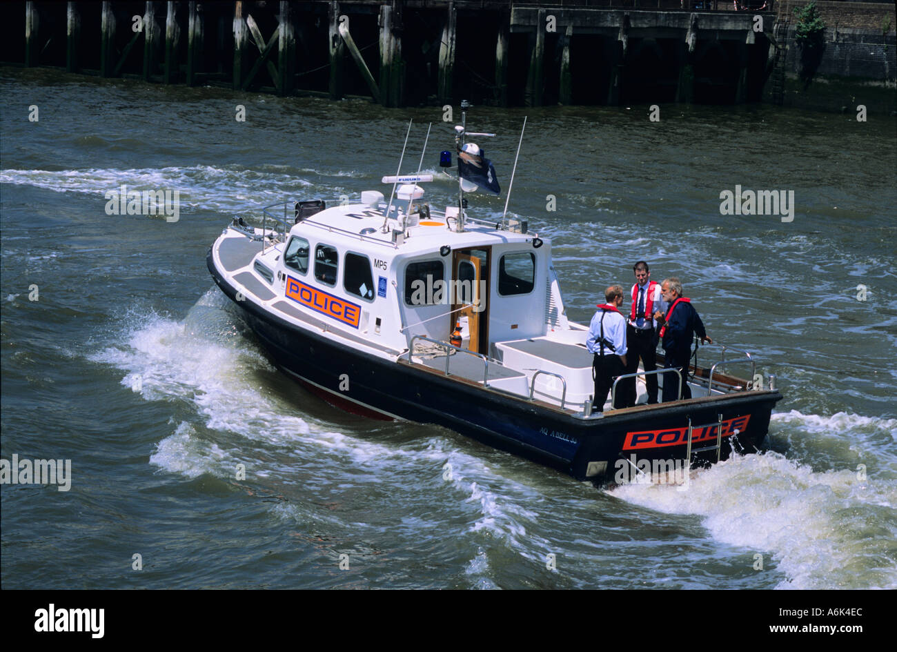 Police boat patrolling along River Thames near Tower Bridge London UK ...