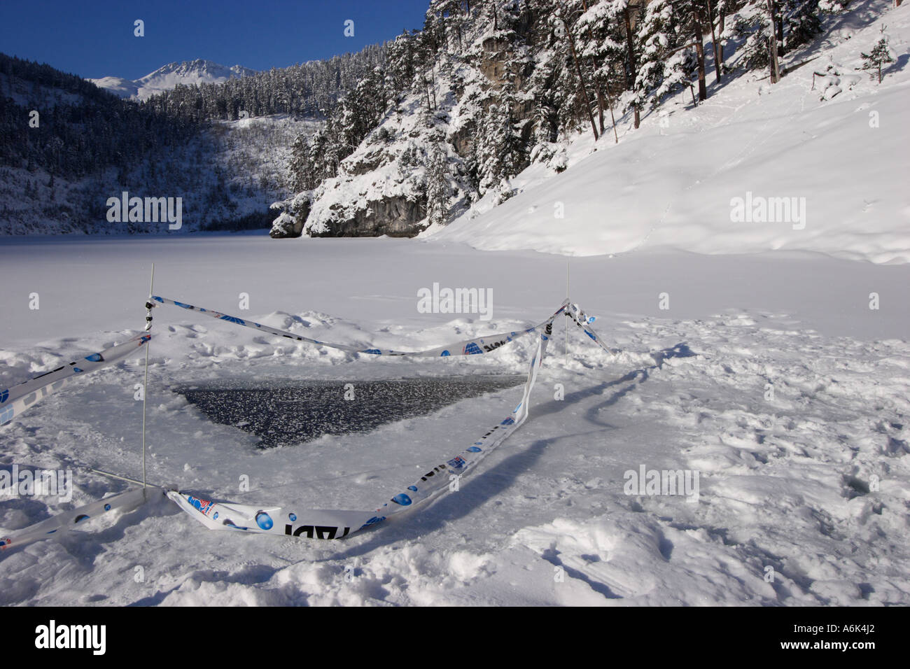 frozen hole for ice diving with barricade for safety Stock Photo - Alamy