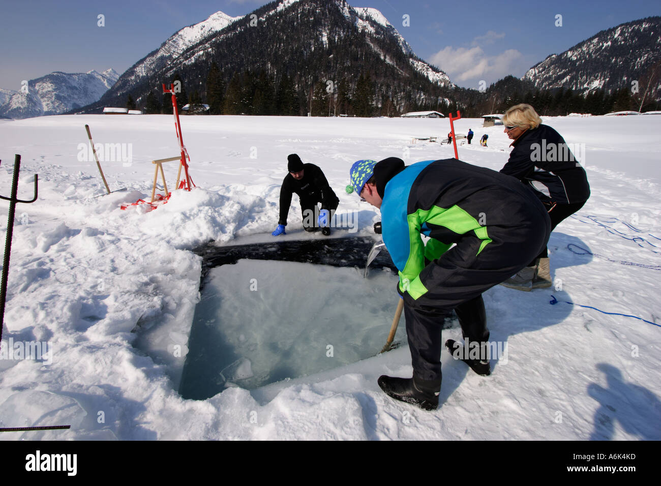 scuba diver opening ice hole on frozen lake Stock Photo - Alamy