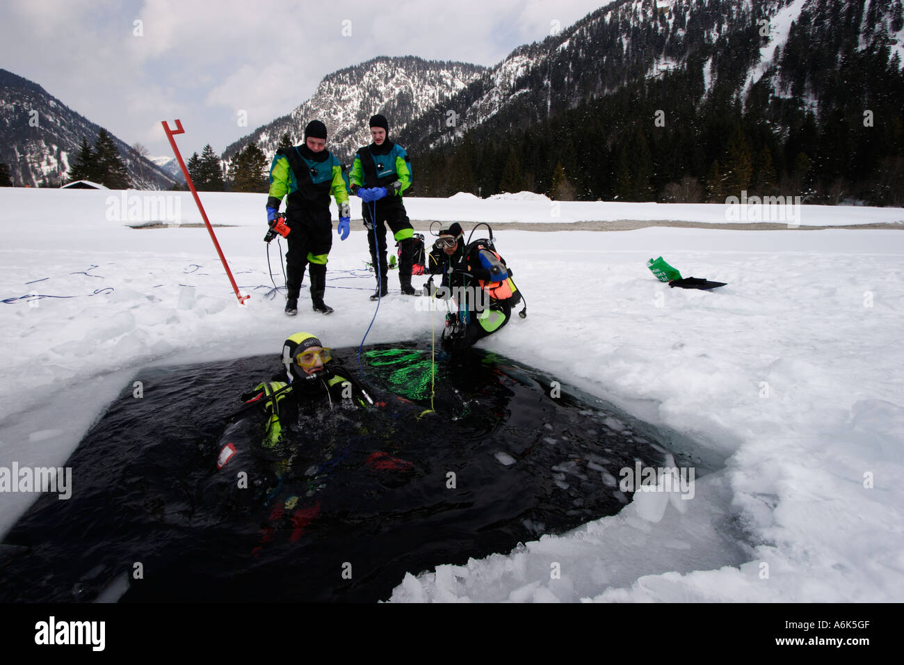 scuba diver with safety rope in ice hole on a frozen lake Stock Photo ...