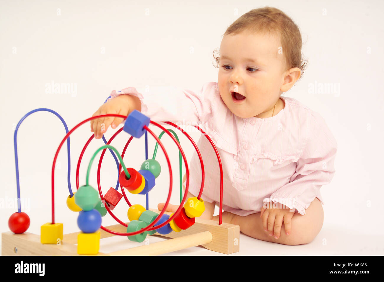 little baby playing on a white backgound Stock Photo - Alamy