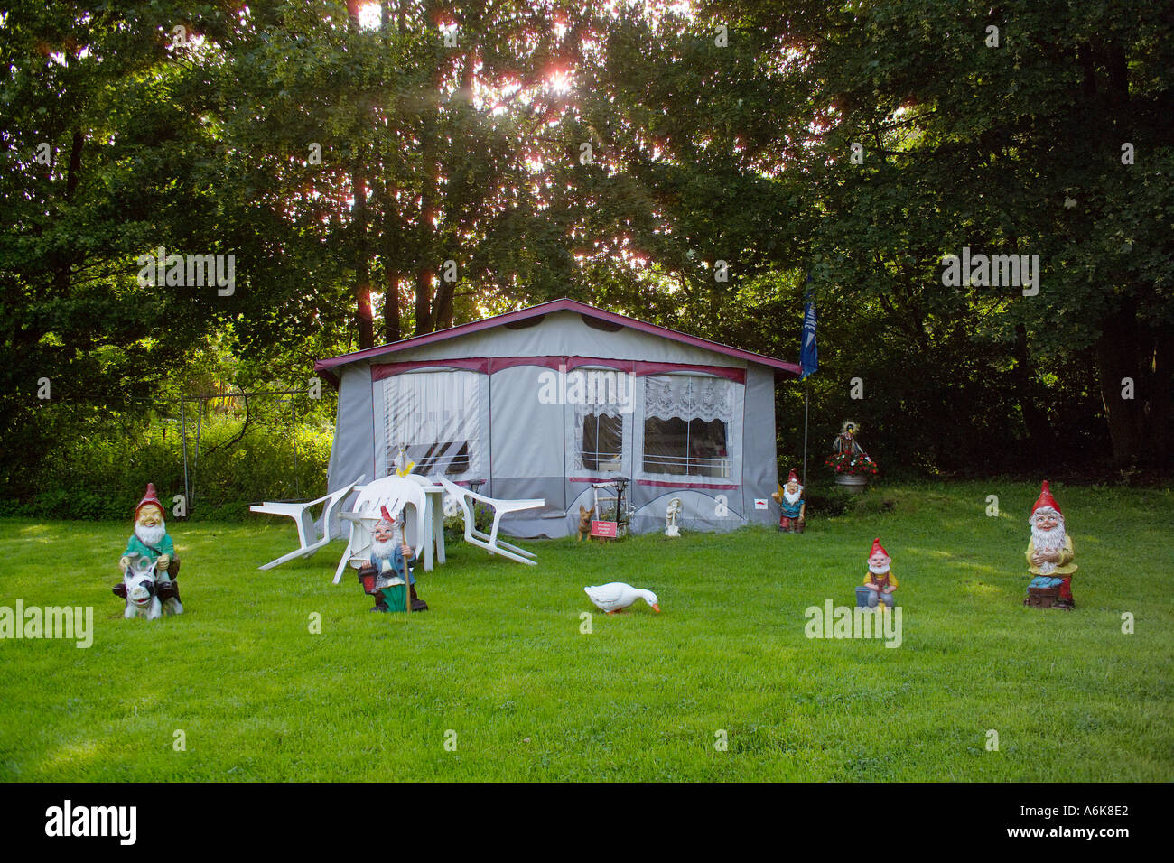 caravan on a campground with garden gnomes in front Stock Photo - Alamy