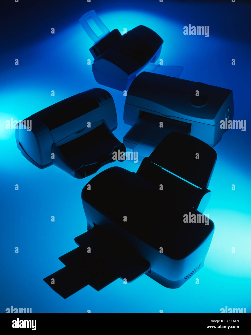 Inkjet printers on a under lit blue acrylic background Stock Photo - Alamy