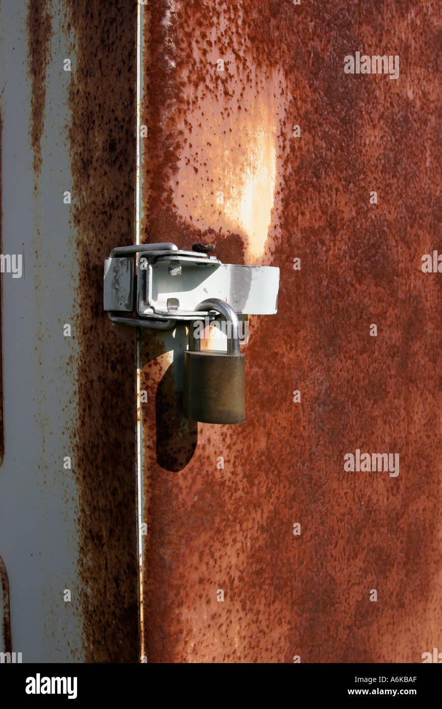 locked panel behind rusty door Stock Photo - Alamy