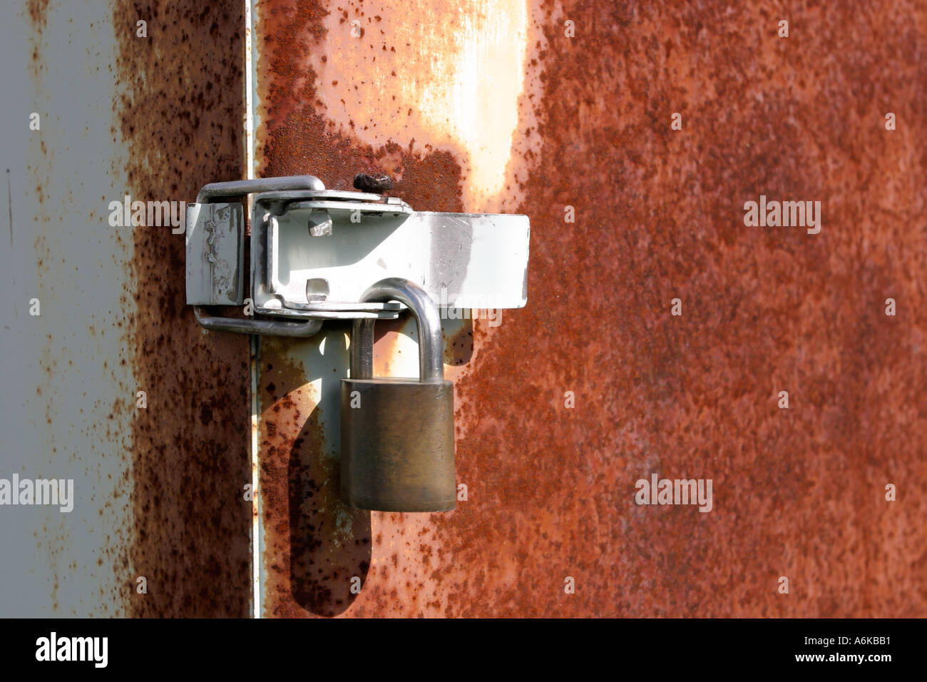 locked panel behind rusty door Stock Photo - Alamy