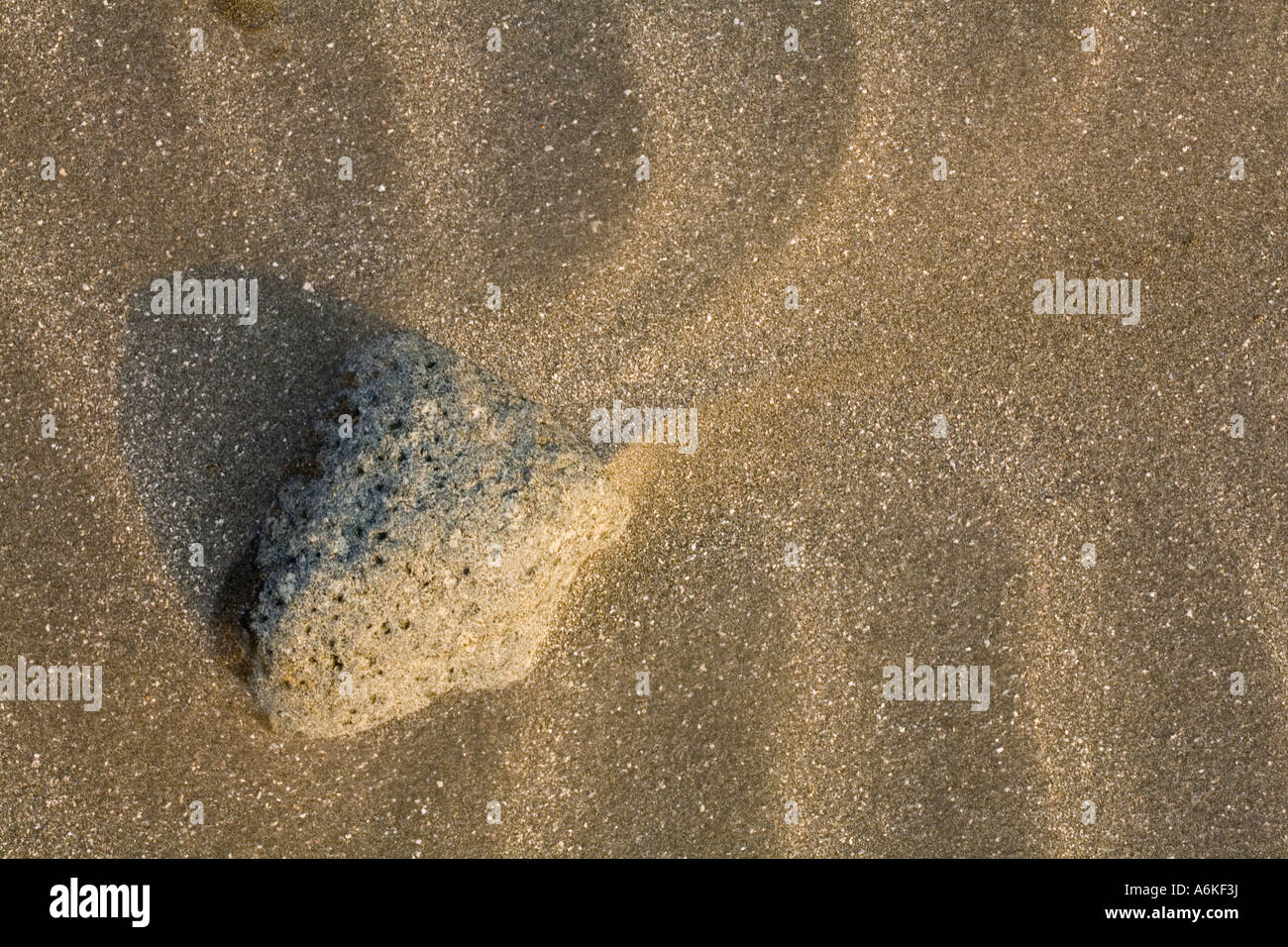 Rock and windblown sand Stock Photo - Alamy