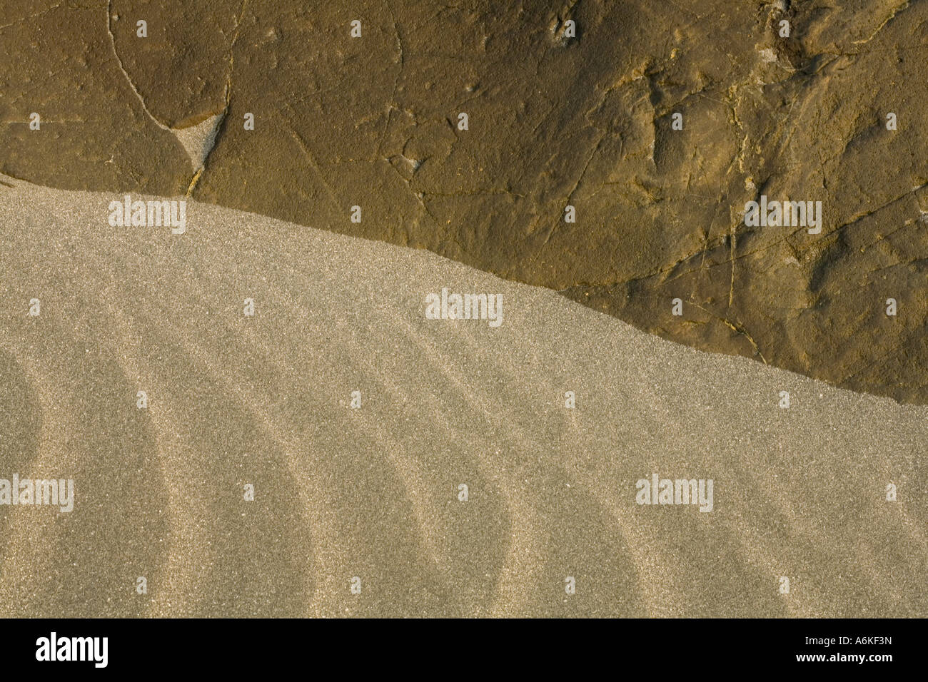 Rock and windblown sand Stock Photo - Alamy