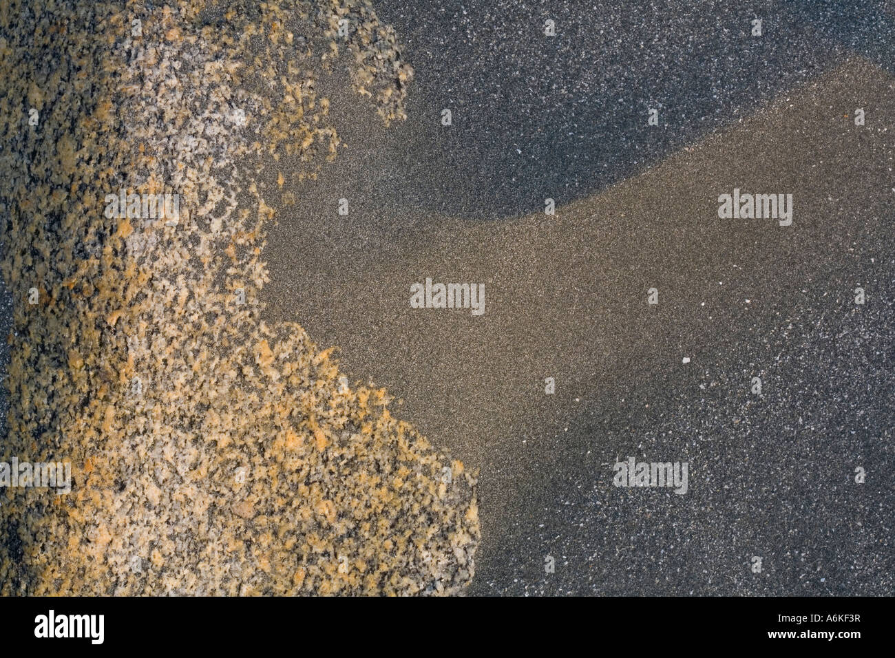 Rock and windblown sand Stock Photo - Alamy