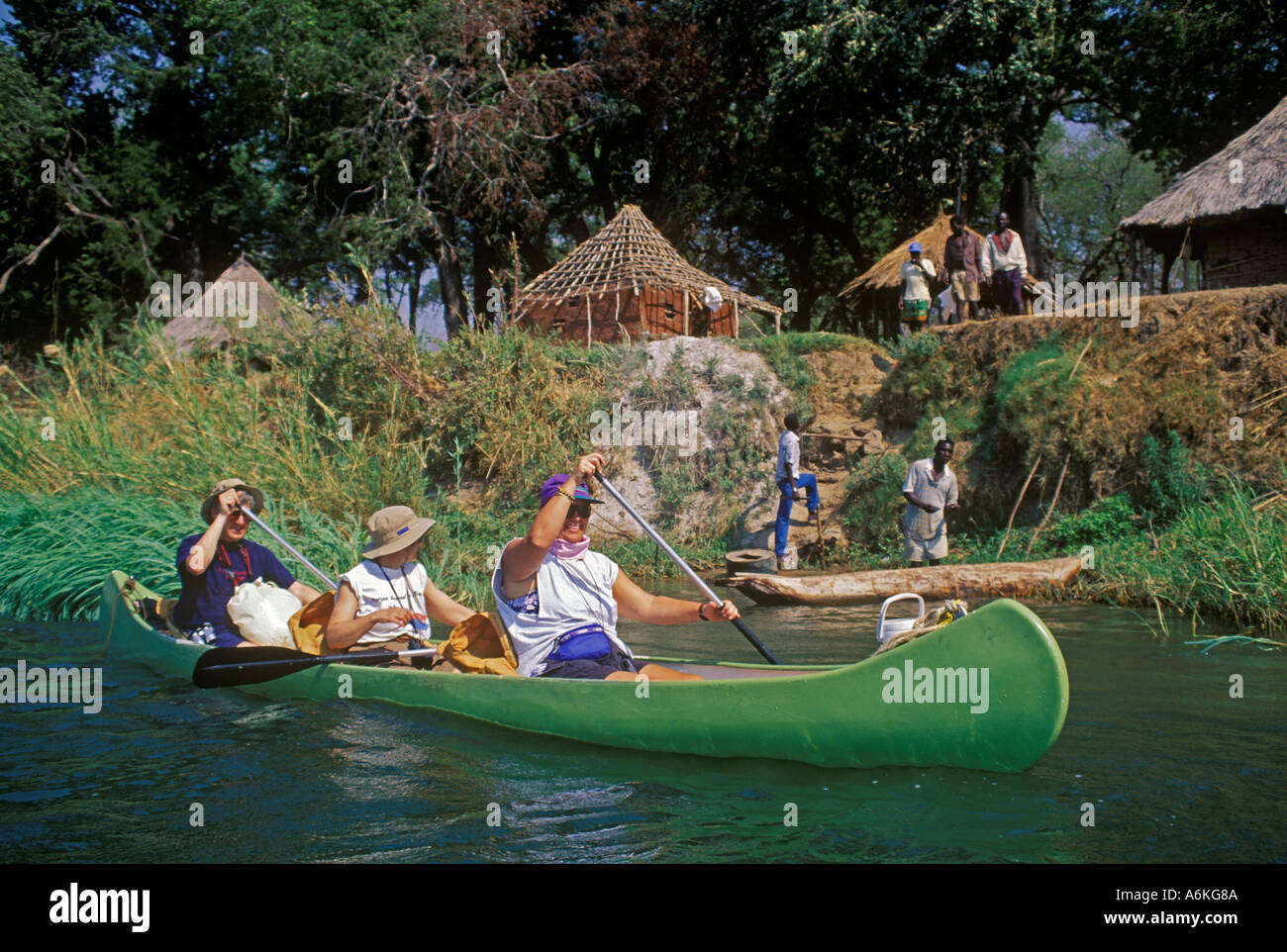CONOE side view of a ZAMBIAN VILLAGE as we paddle the mighty ZAMBEZI ...