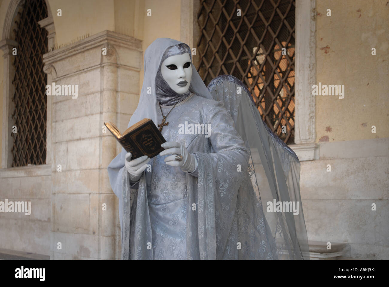 Angel reading book during Venice Carnival Stock Photo - Alamy