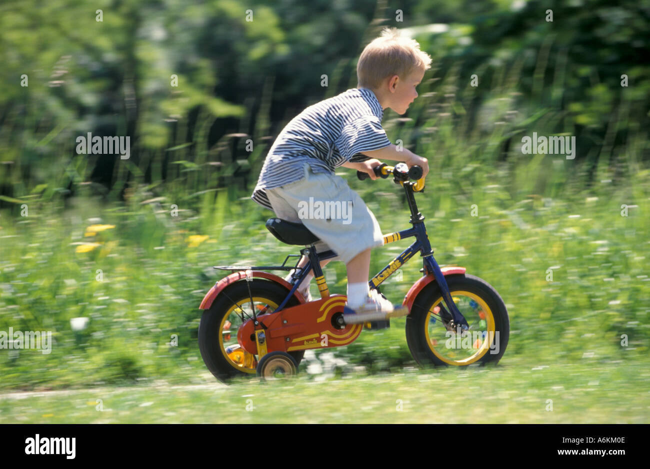 Little boy racing with bike Stock Photo - Alamy