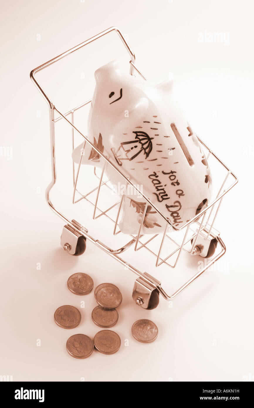 Coins and Piggy Bank in Shopping Trolley Stock Photo - Alamy