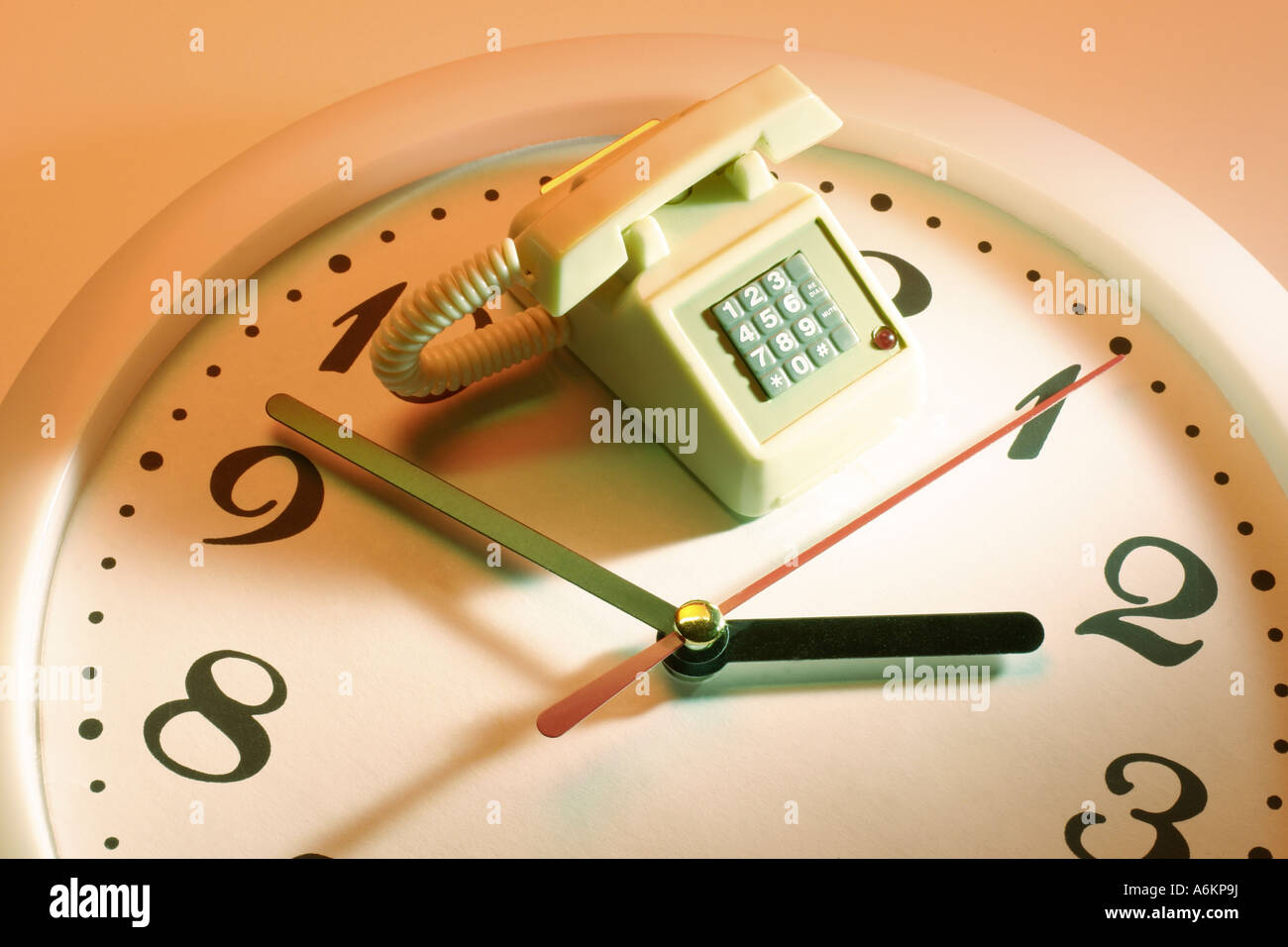 Miniature Phone on Clock Stock Photo - Alamy