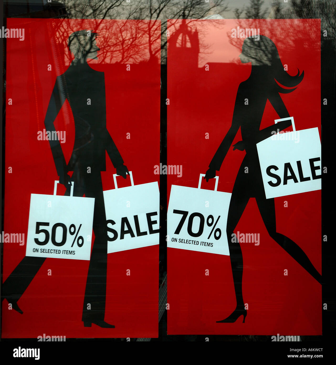 Male and Female figures printed on posters on Sale signs in shop window ...