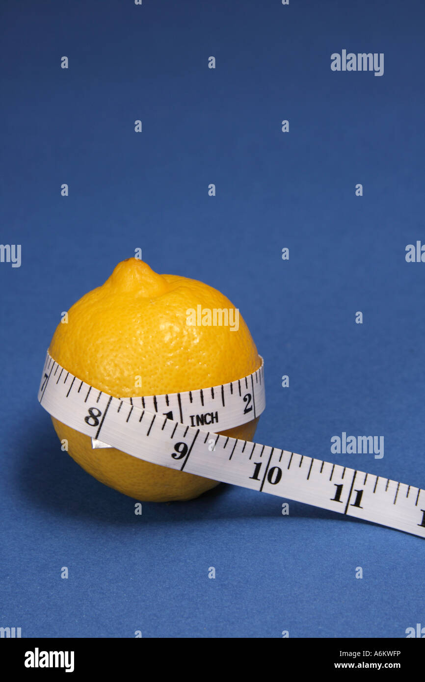 Measuring tape wrapped around a lemon. Concept of diet Stock Photo - Alamy