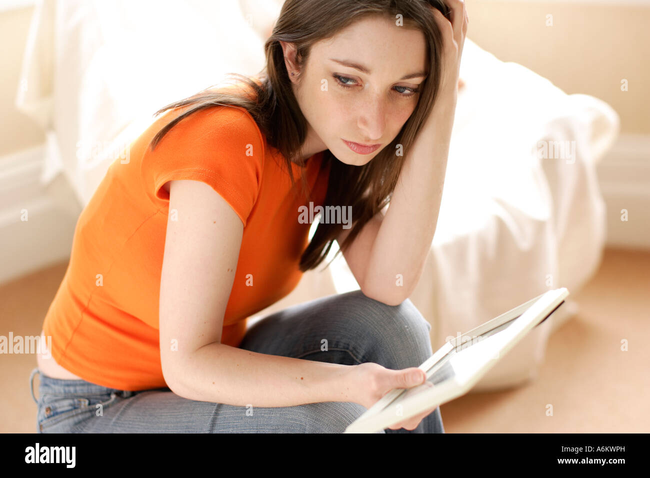 Sad girl with photo frame Stock Photo - Alamy