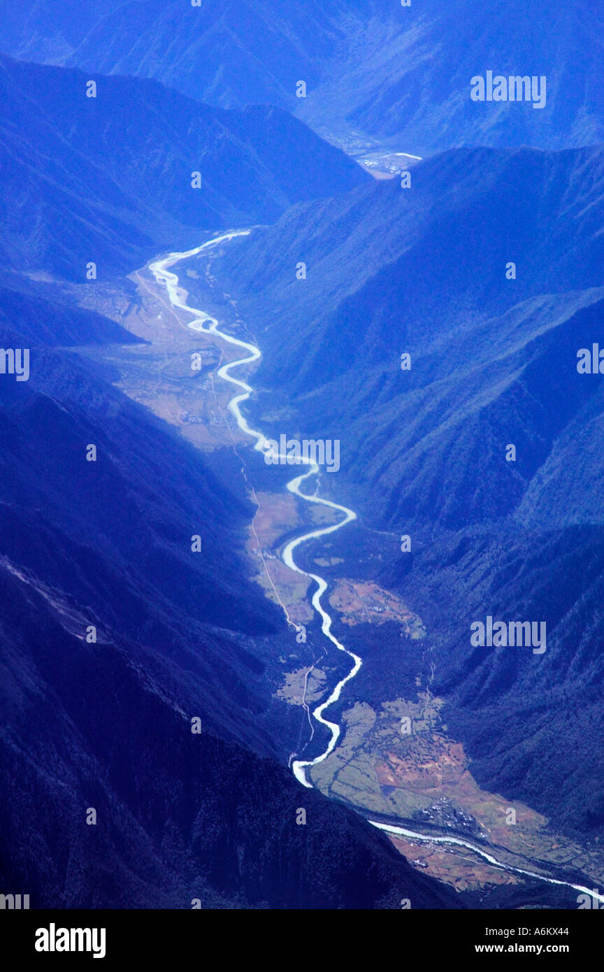 Aerial view of river flowing through mountain valleys Himalayas Tibetan ...