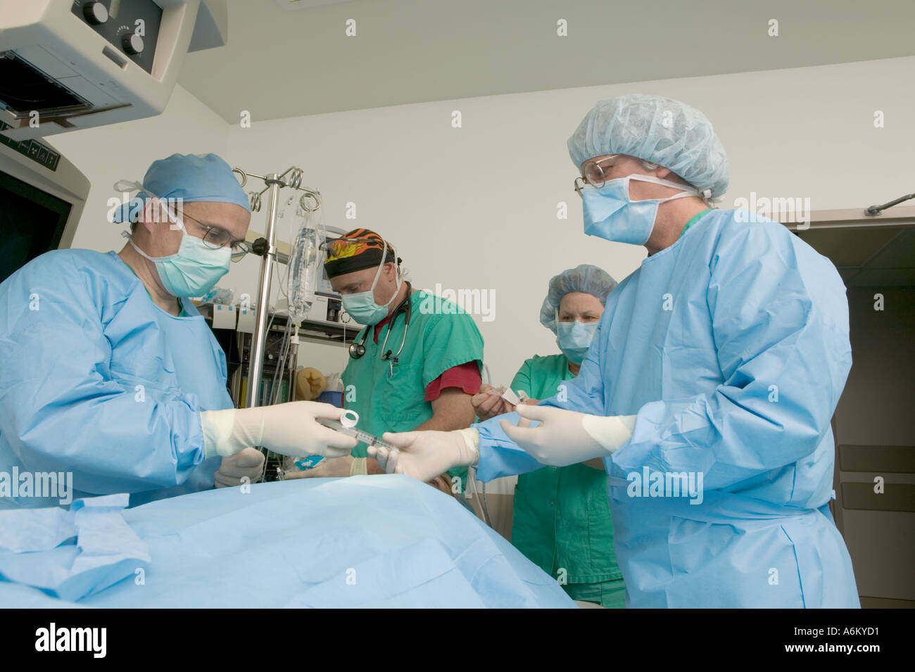Nurses and doctors during surgery passing instruments Stock Photo - Alamy