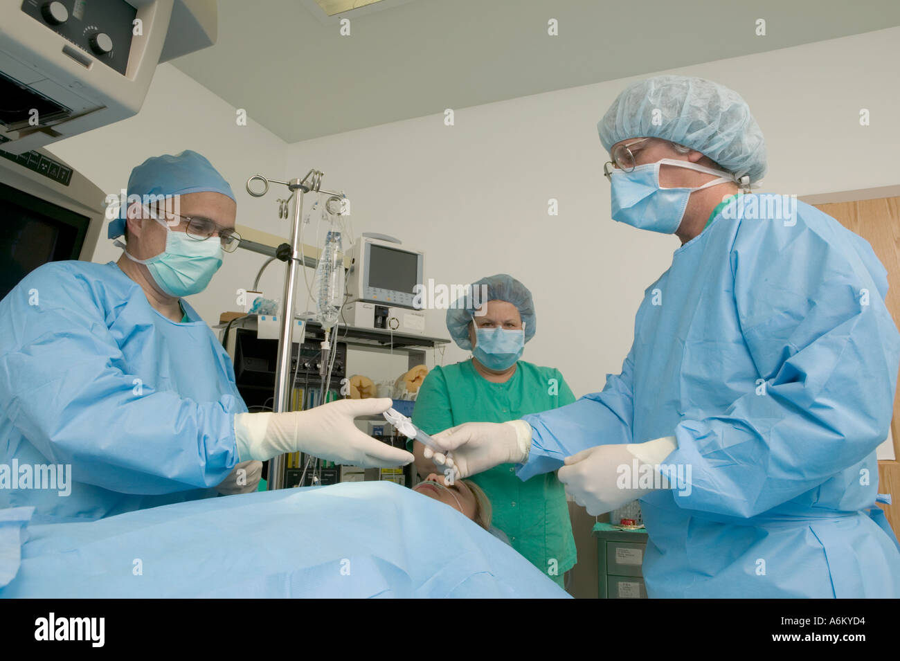 Nurses and doctors during surgery passing instruments Stock Photo - Alamy
